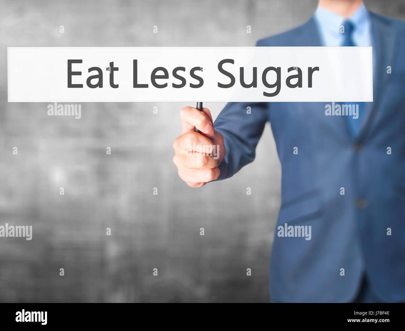 Eat Less Sugar - Businessman hand holding sign. Business, technology ...