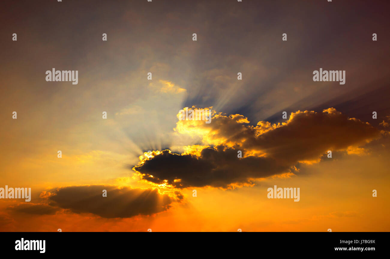 golden color of beautiful dramatic dusky sky in evening show ray light ...