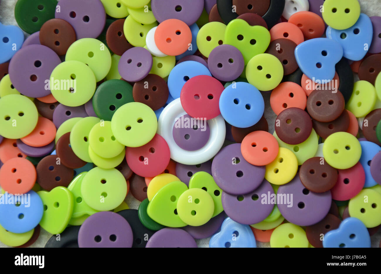 Assorted colorful buttons ready for sewing Stock Photo - Alamy