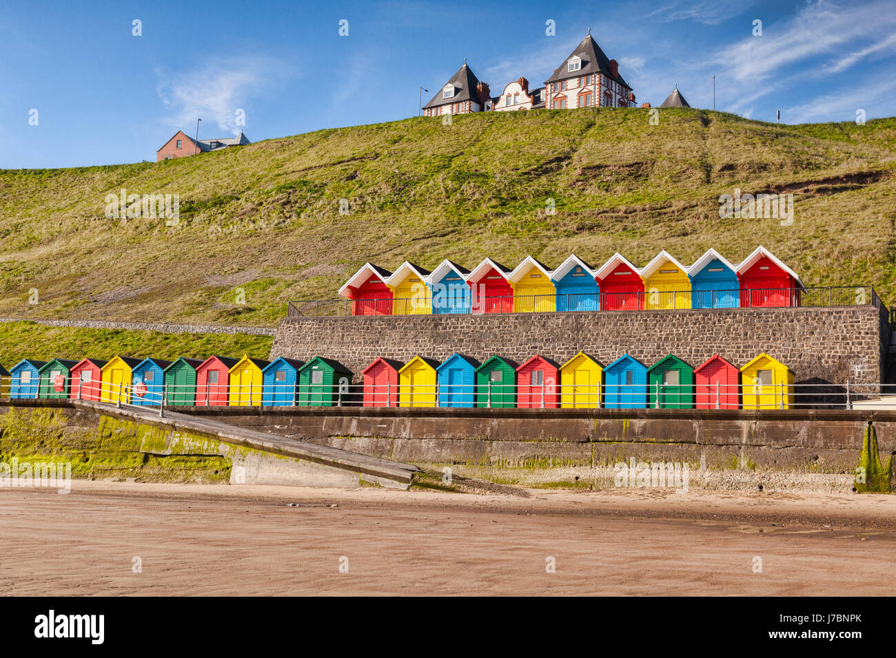 Rows of colorful beach huts on the promenade at Whitby Sands, Whitby ...