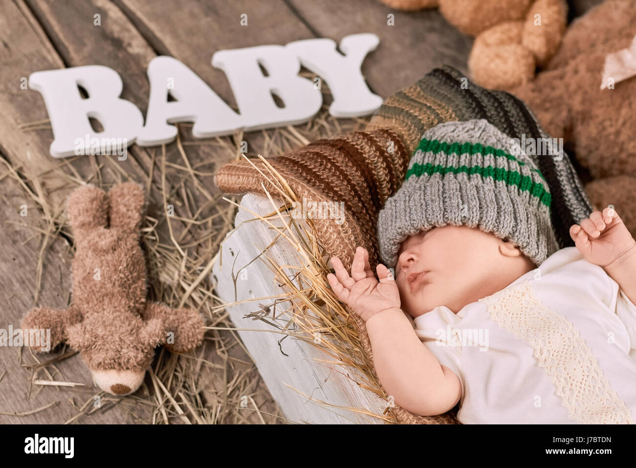 Adorable sleeping baby. Kid lying on hay Stock Photo - Alamy