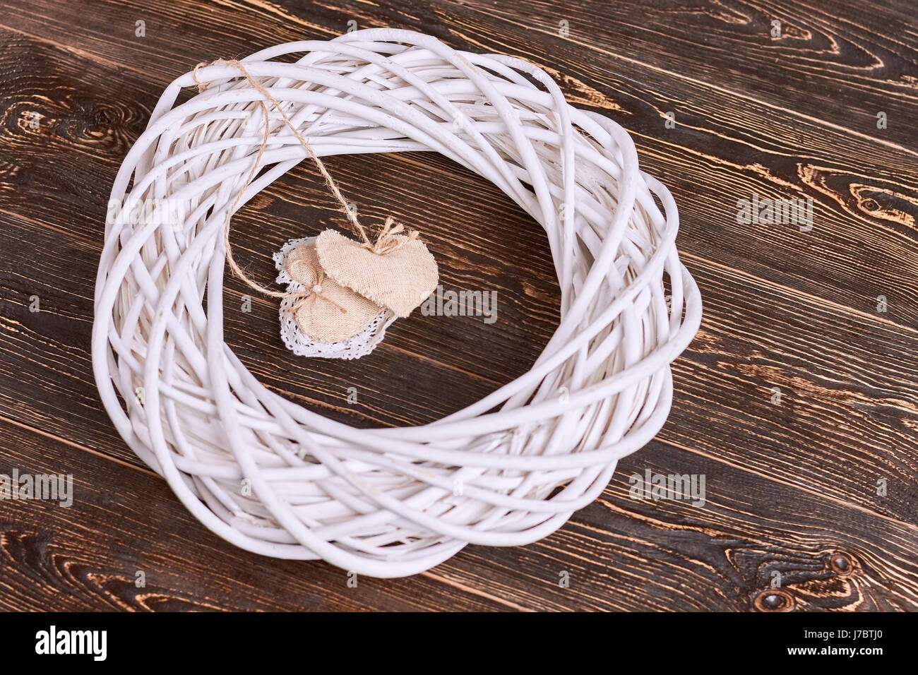 Fabric hearts on brown wood. White willow wreath. Nest of love Stock ...
