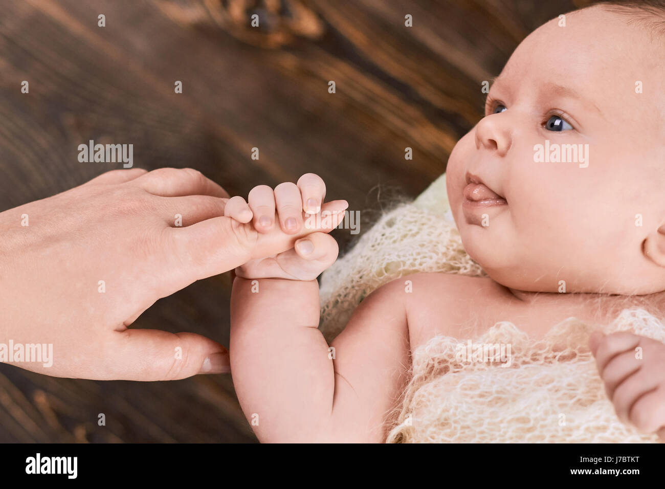 Baby holding finger of woman. Caucasian child close up. What makes a ...