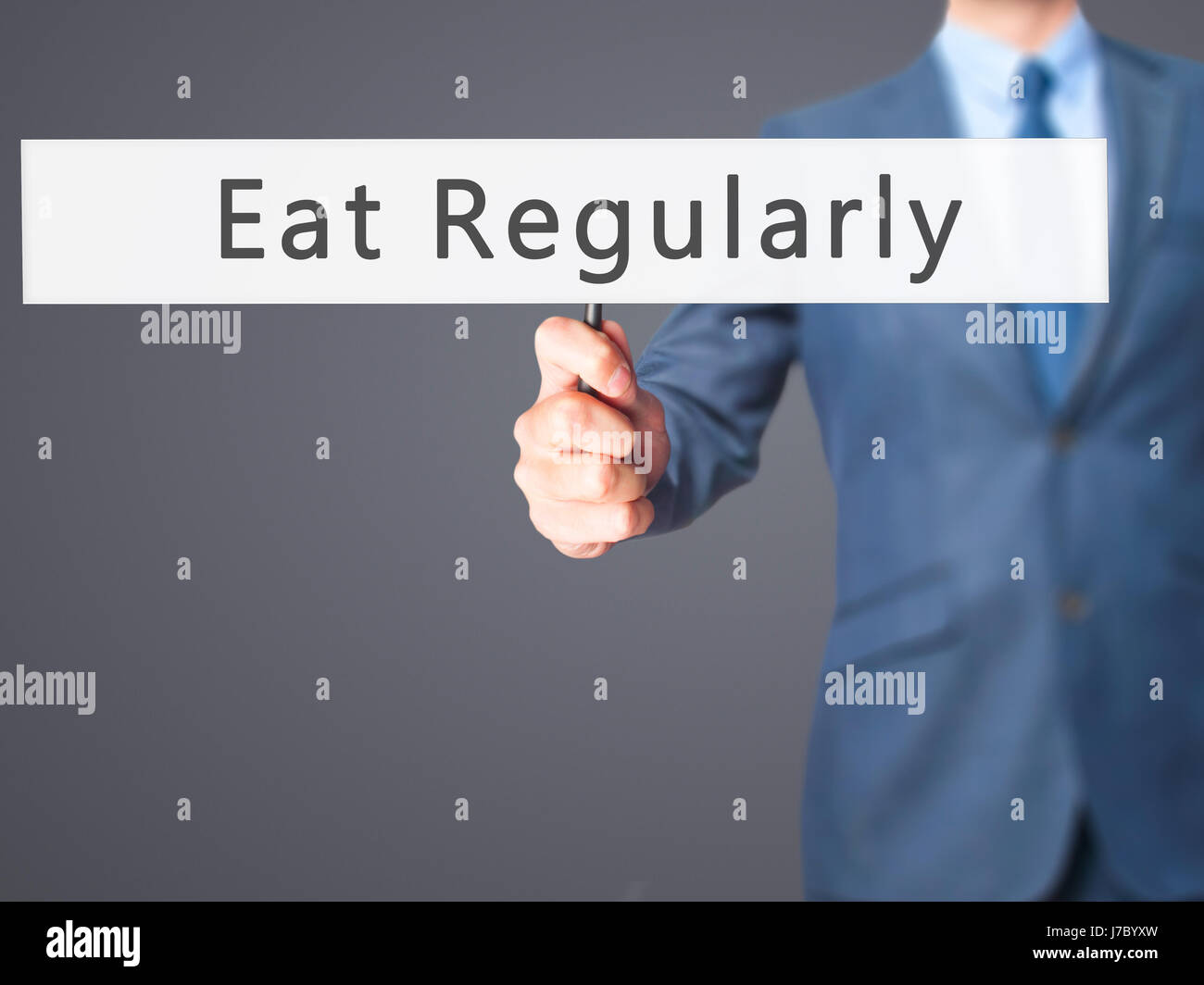 Eat Regularly - Businessman hand holding sign. Business, technology ...