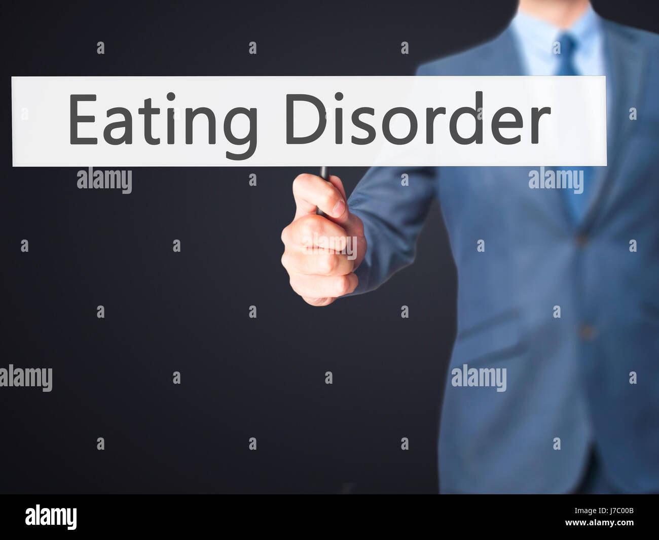 Eating Disorder - Businessman hand holding sign. Business, technology ...