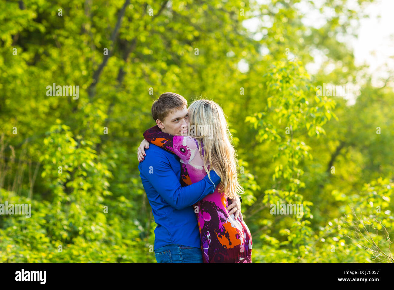 beautiful young couple hugging in the summer park Stock Photo - Alamy