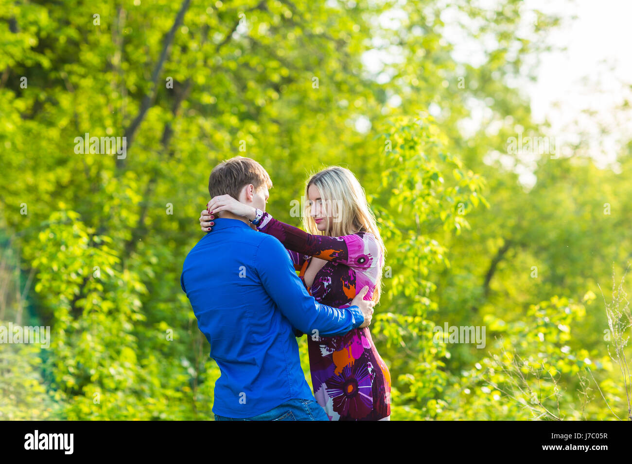 beautiful young couple hugging in the summer park Stock Photo - Alamy
