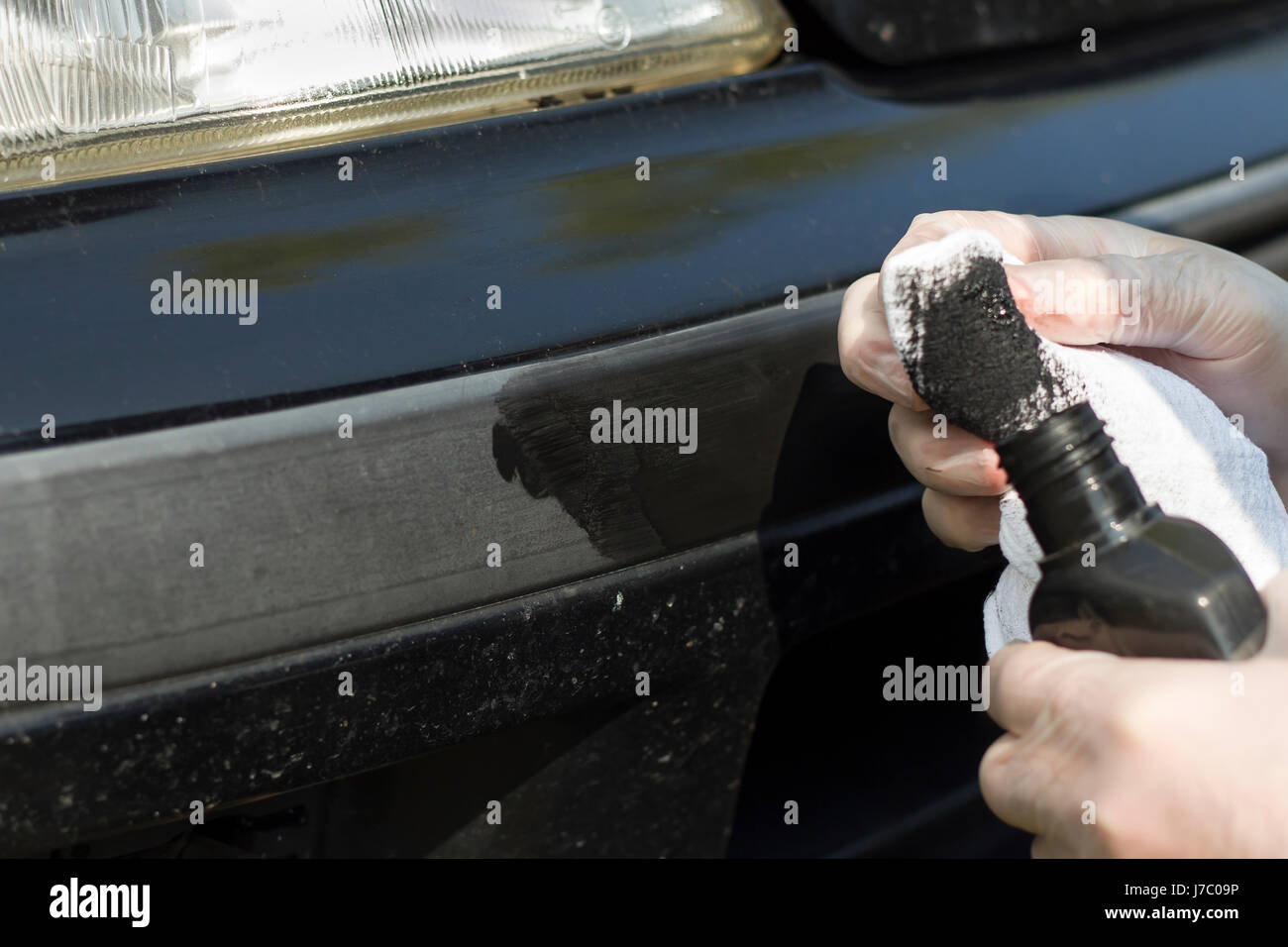 The man's hands apply a plastic paste to a white cloth. Man's hand puts ...
