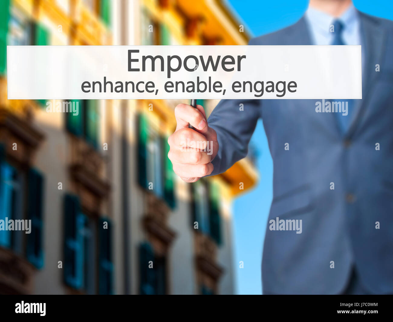 Empower enhance, enable, engage - Businessman hand holding sign ...