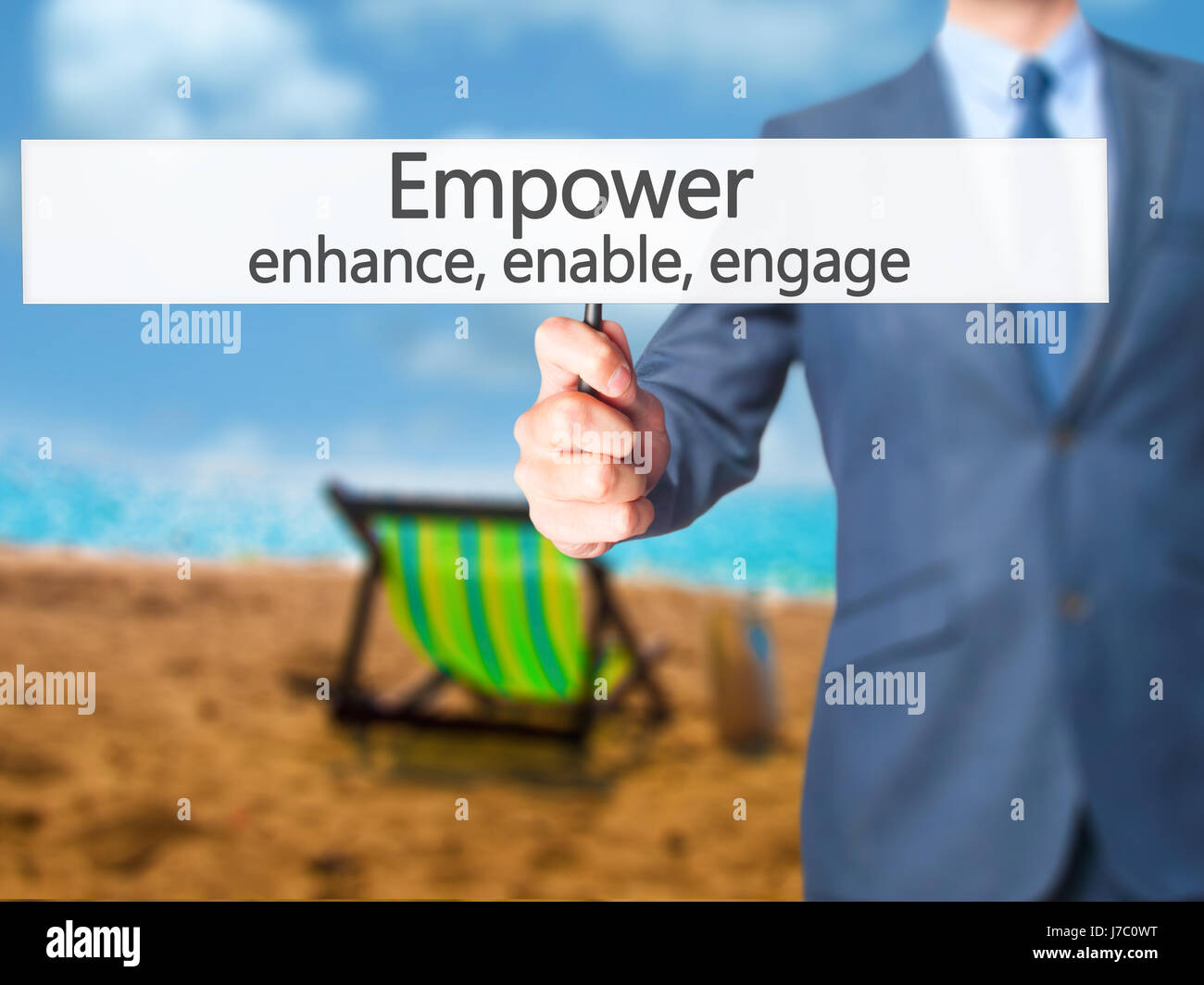 Empower enhance, enable, engage - Businessman hand holding sign ...