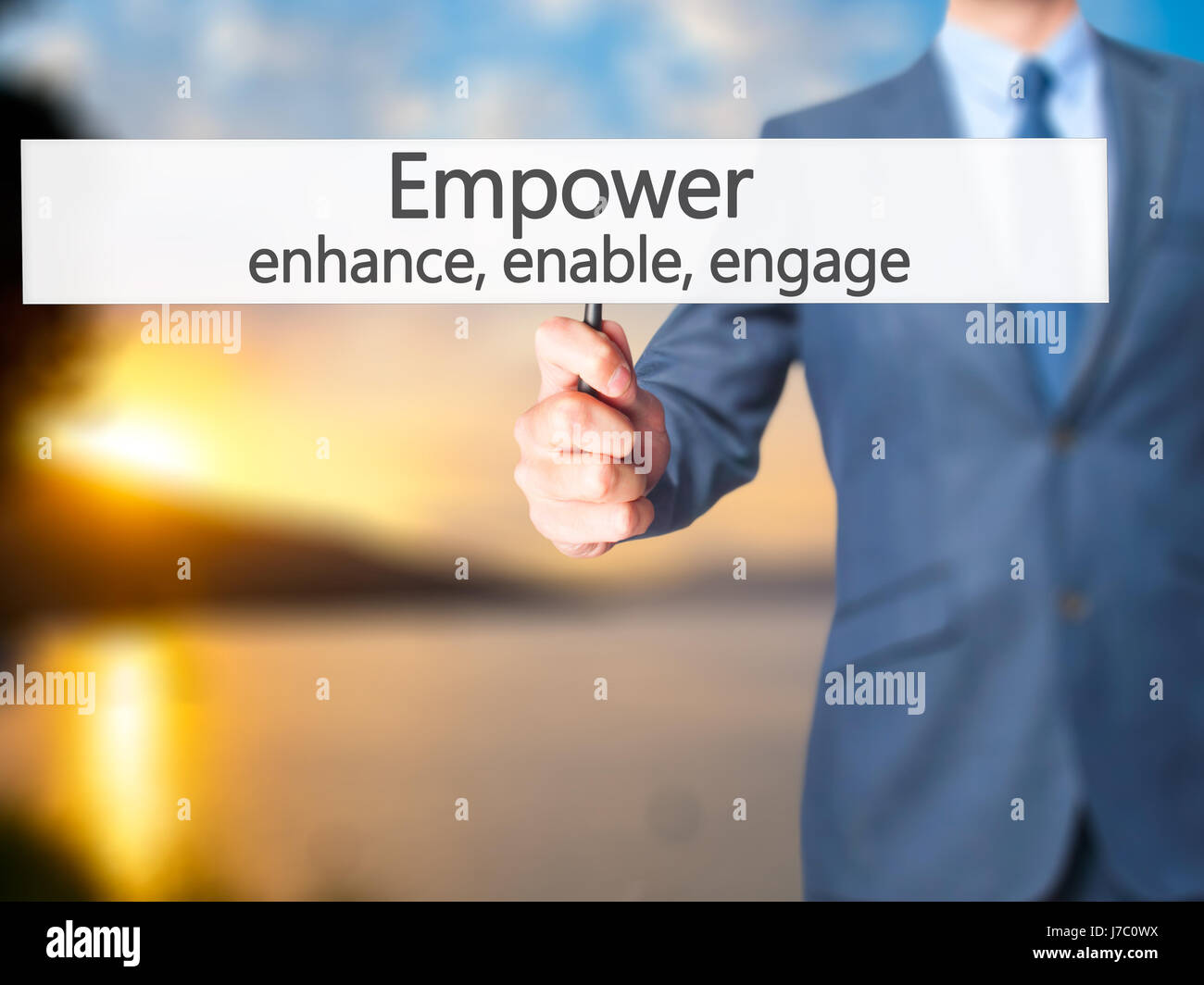 Empower enhance, enable, engage - Businessman hand holding sign ...
