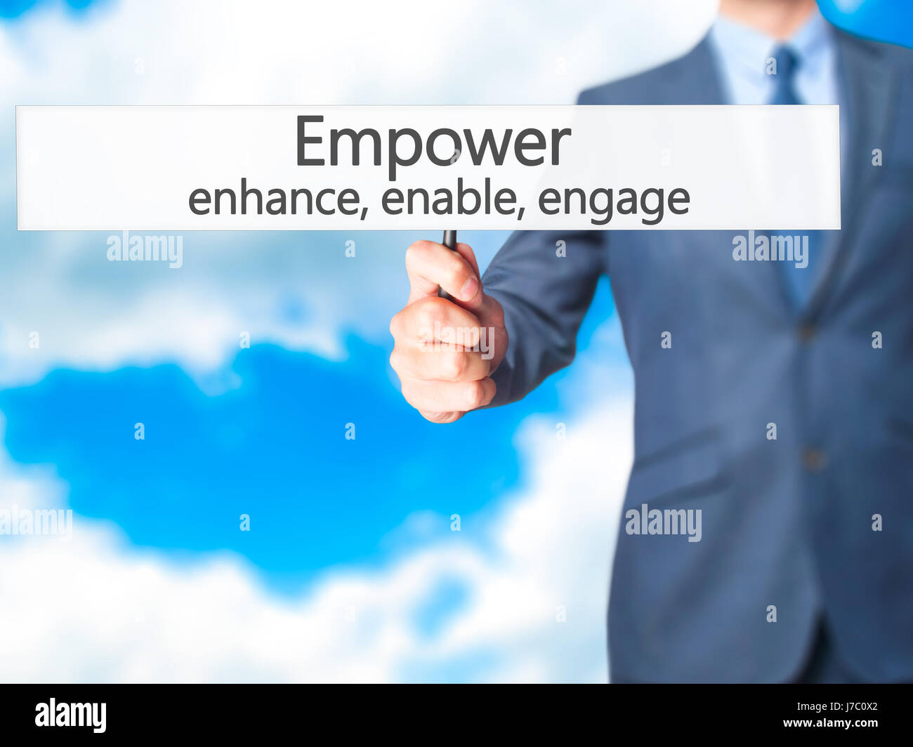 Empower enhance, enable, engage - Businessman hand holding sign ...