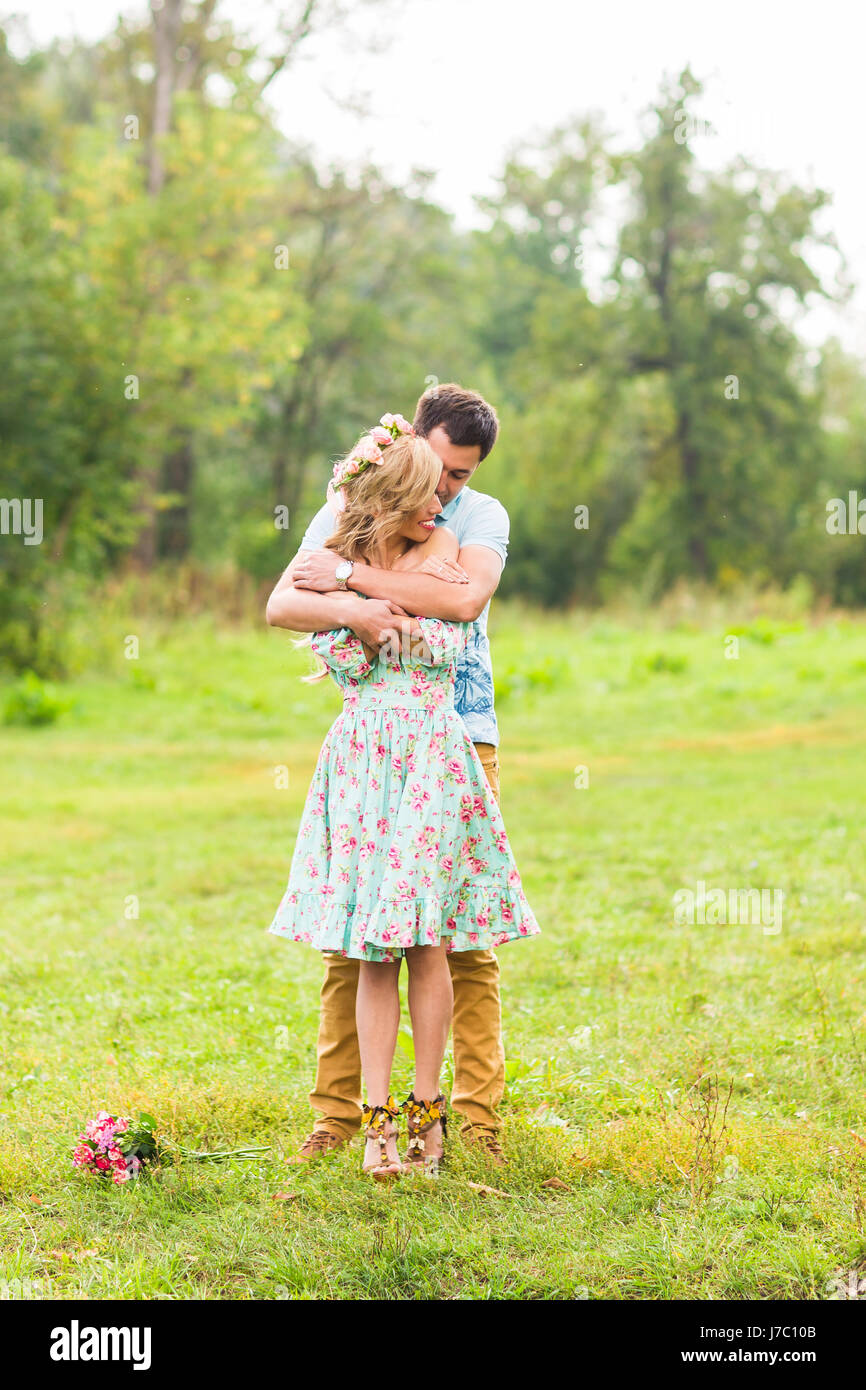 beautiful young couple hugging in the park Stock Photo - Alamy
