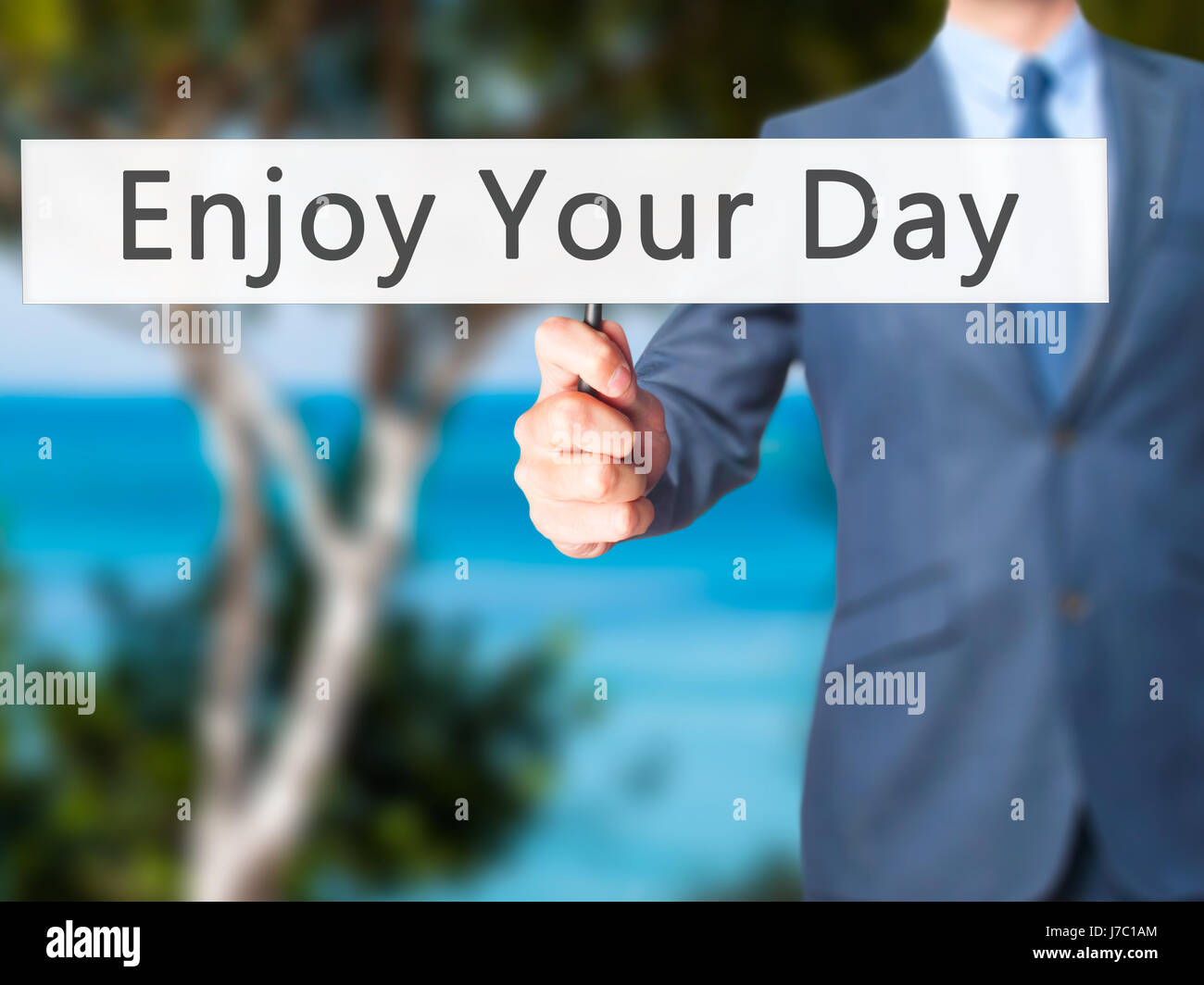 Enjoy Your Day - Businessman hand holding sign. Business, technology ...