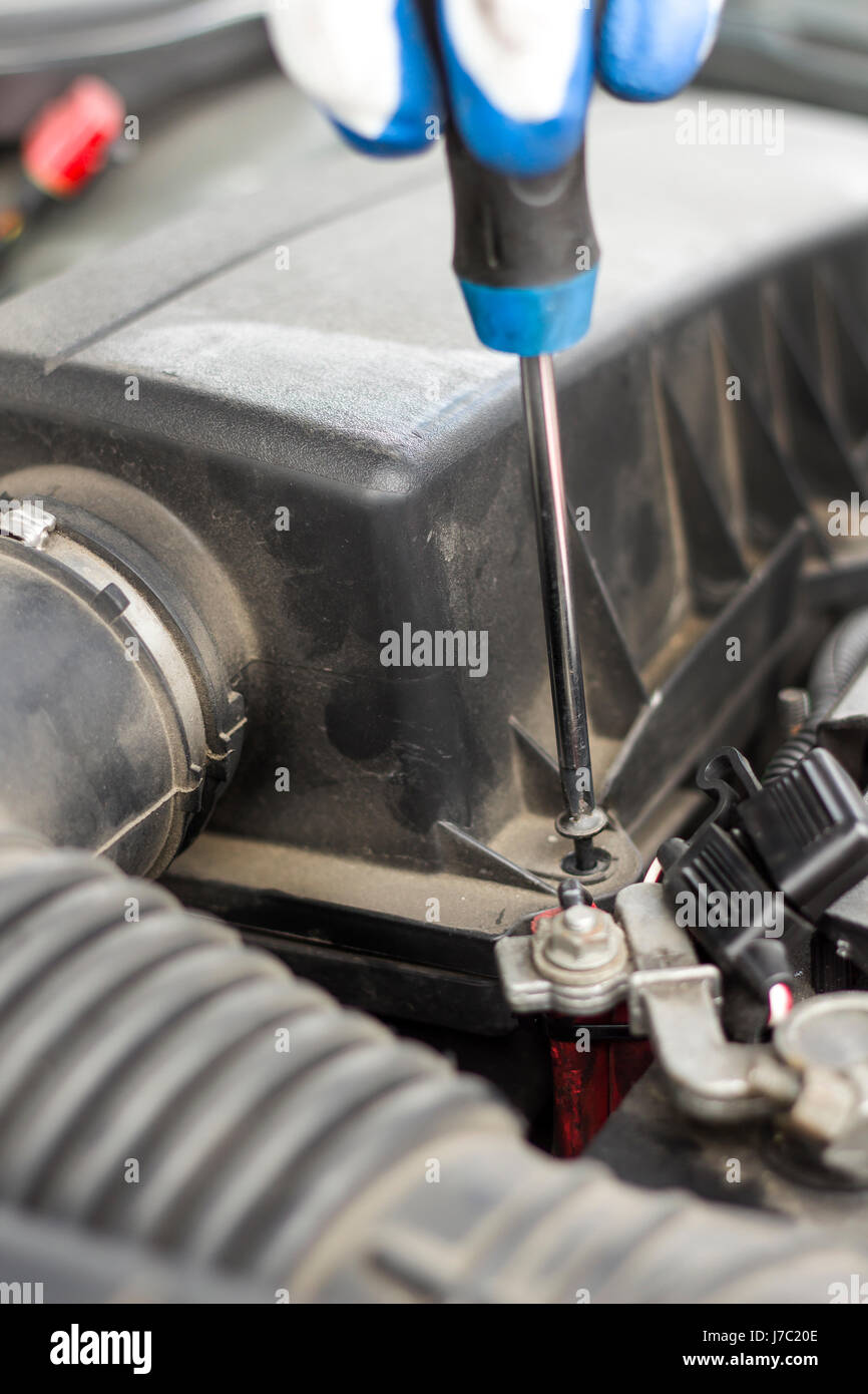 Unscrew the screw from the air filter cover with a screwdriver. The ...