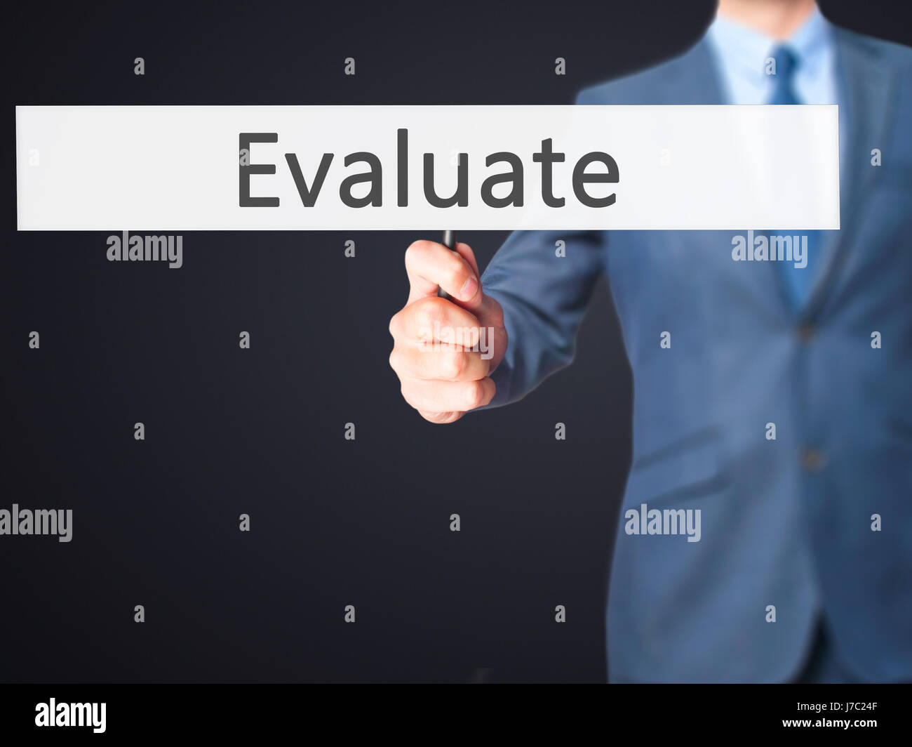Evaluate - Businessman hand holding sign. Business, technology ...