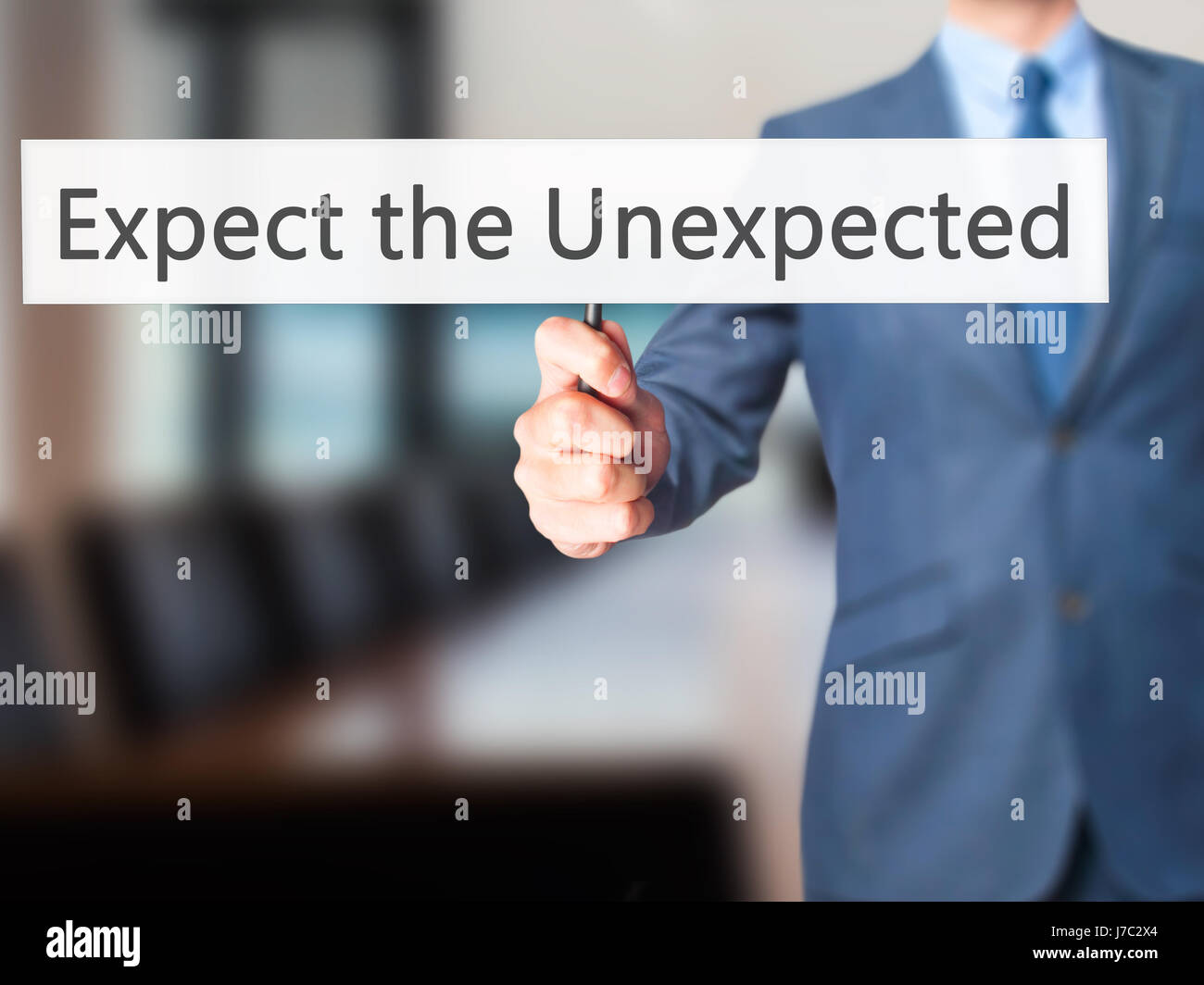 Expect the Unexpected - Businessman hand holding sign. Business ...