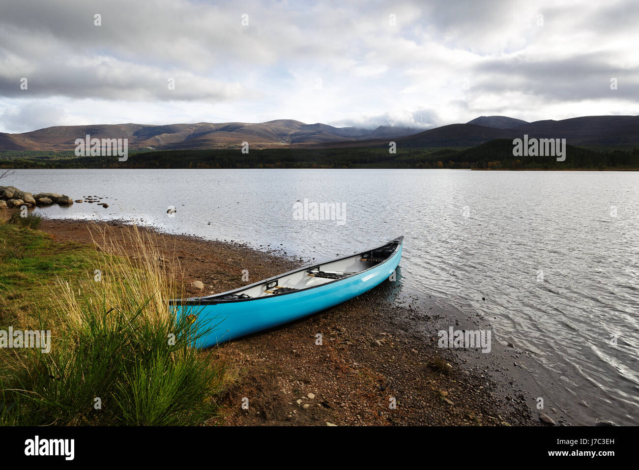 Blue canoe on the lake in Scotland, UK Stock Photo - Alamy