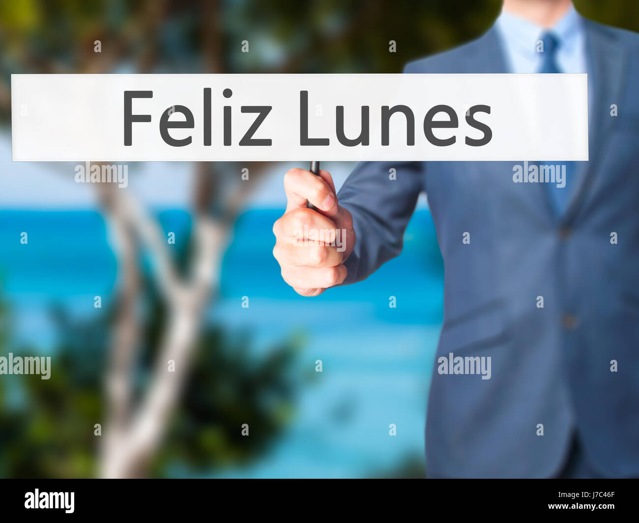 Feliz Lunes (Happy Monday In Spanish) - Businessman hand holding sign ...