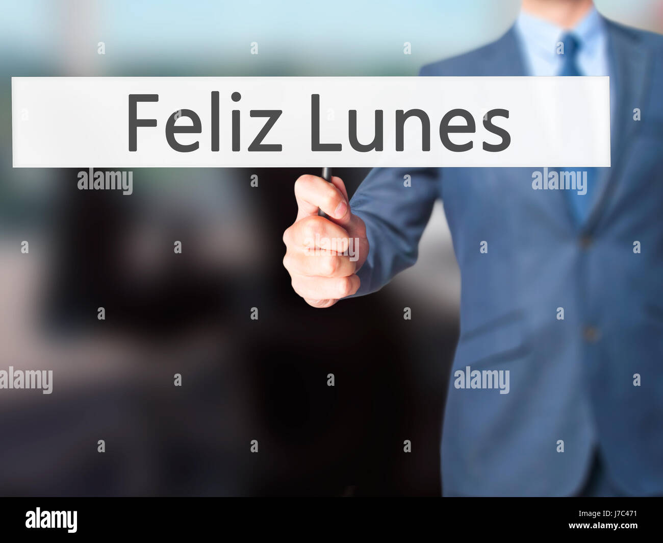 Feliz Lunes (Happy Monday In Spanish) - Businessman hand holding sign ...
