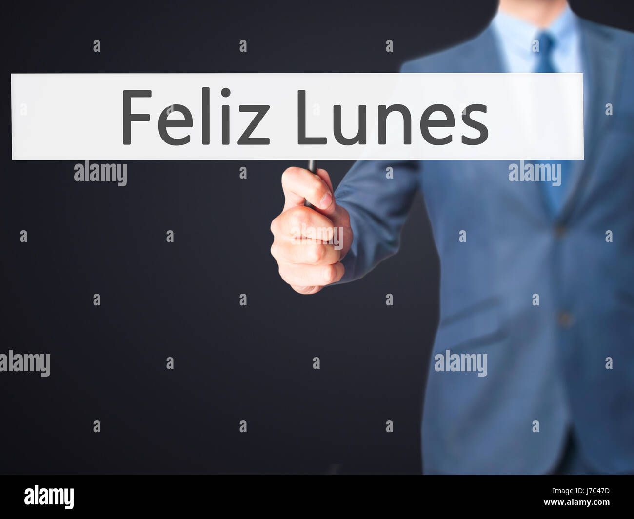 Feliz Lunes (Happy Monday In Spanish) - Businessman hand holding sign ...