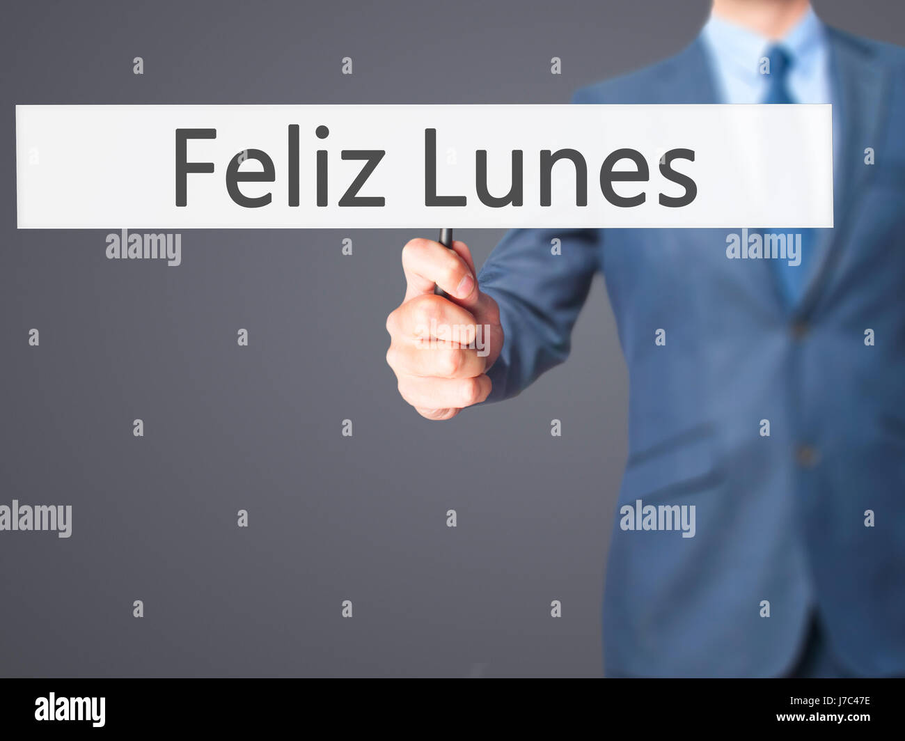 Feliz Lunes (Happy Monday In Spanish) - Businessman hand holding sign ...