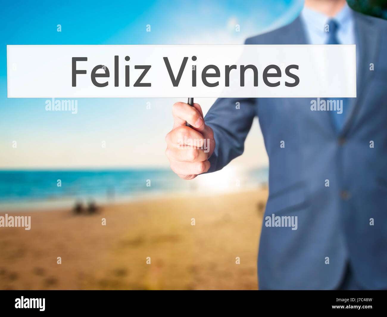 Feliz Viernes (Happy Friday In Spanish) - Businessman hand holding sign ...