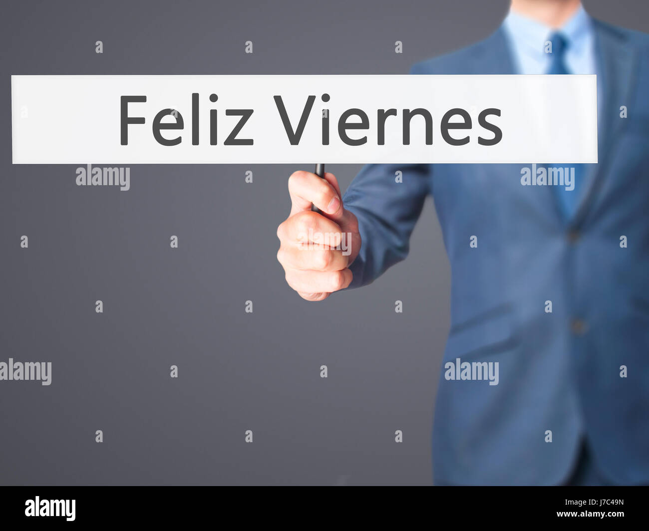 Feliz Viernes (Happy Friday In Spanish) - Businessman hand holding sign ...