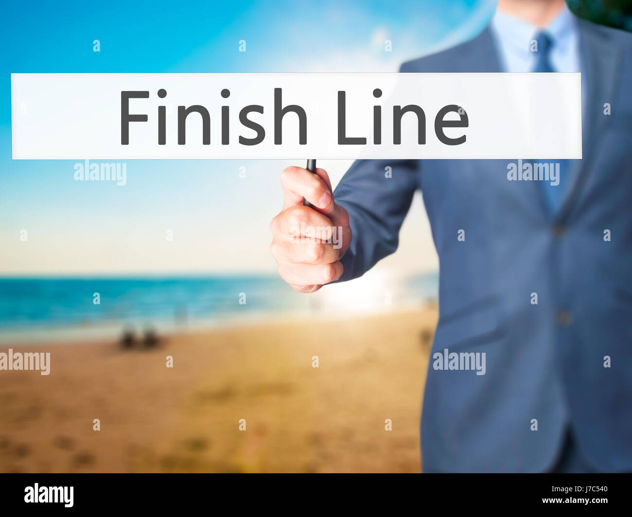 Finish Line - Businessman hand holding sign. Business, technology ...