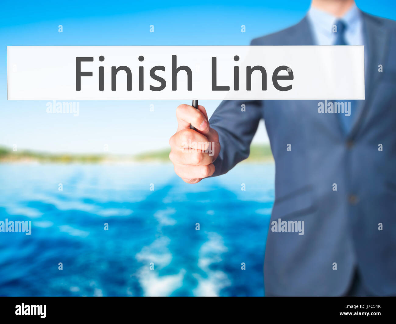 Finish Line - Businessman hand holding sign. Business, technology ...