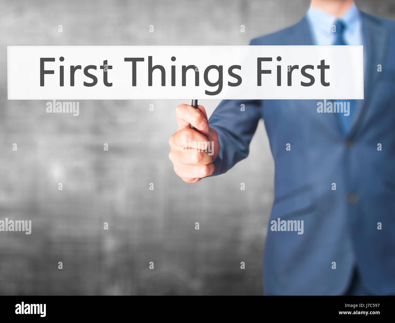 First Things First - Businessman hand holding sign. Business ...
