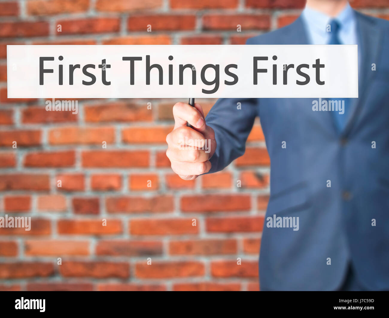 First Things First - Businessman hand holding sign. Business ...