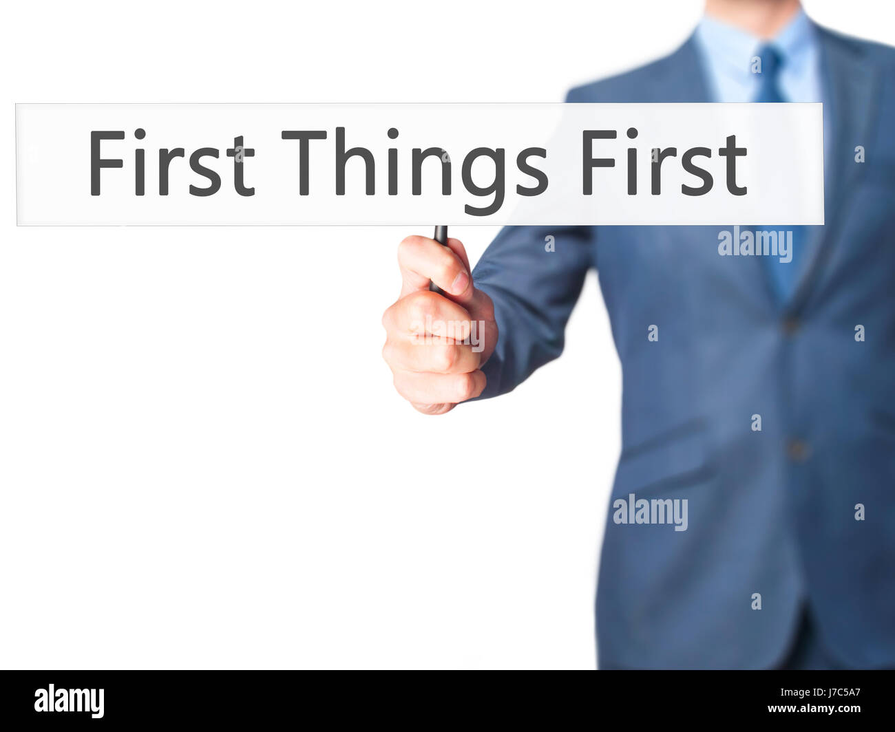 First Things First - Businessman hand holding sign. Business ...