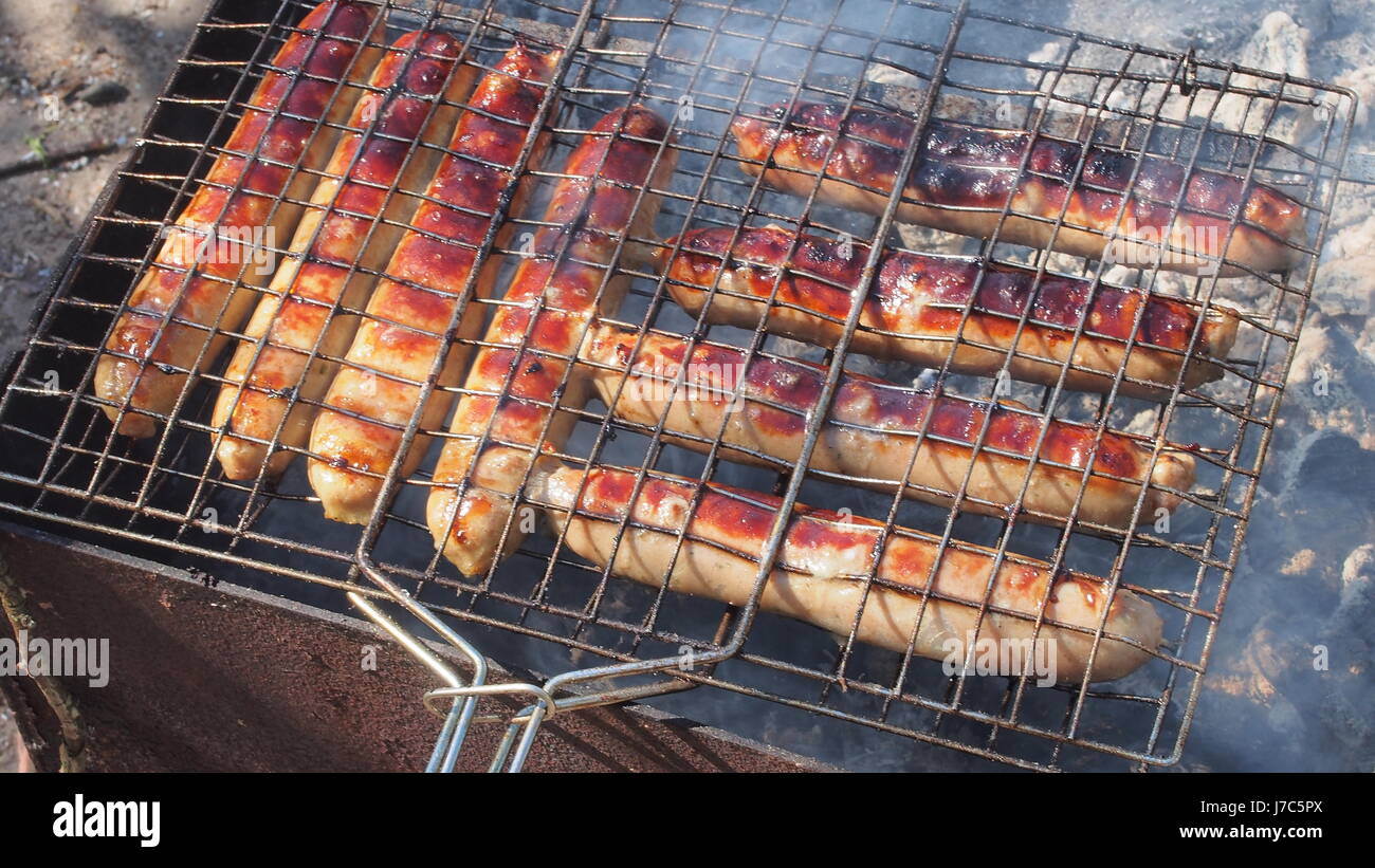 Grilled sausages, cooked on the grill. Barbecue. Still life Stock Photo ...