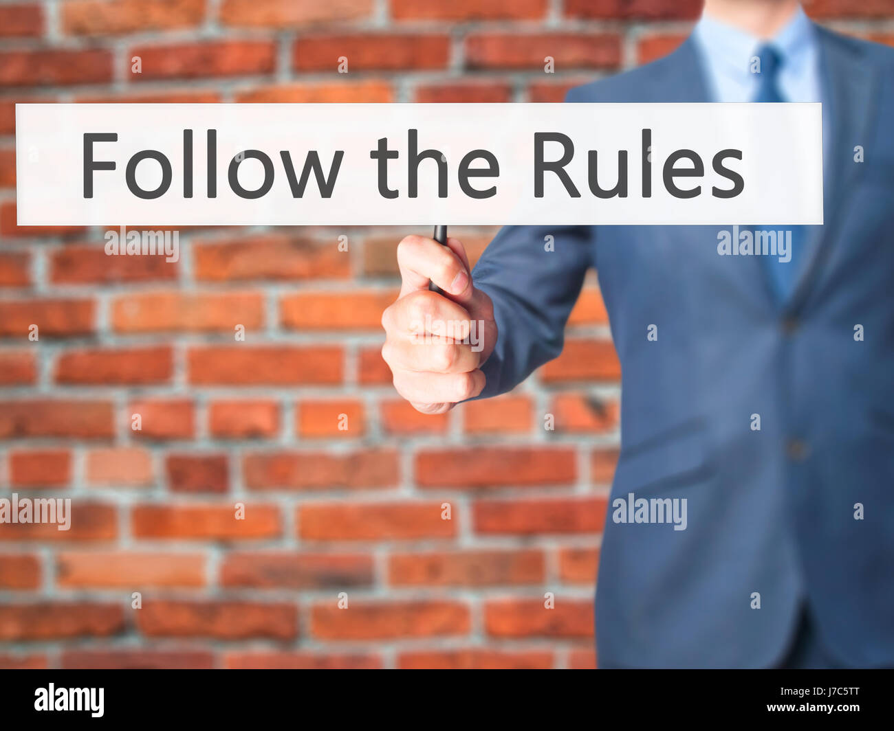 Follow the Rules - Businessman hand holding sign. Business, technology ...