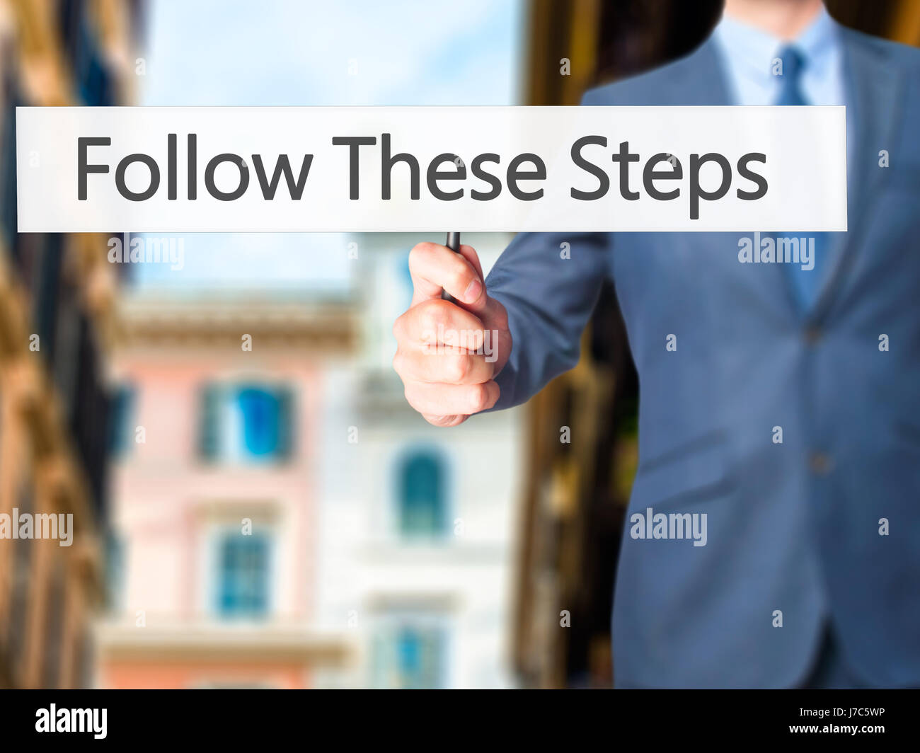 Follow These Steps - Businessman hand holding sign. Business ...