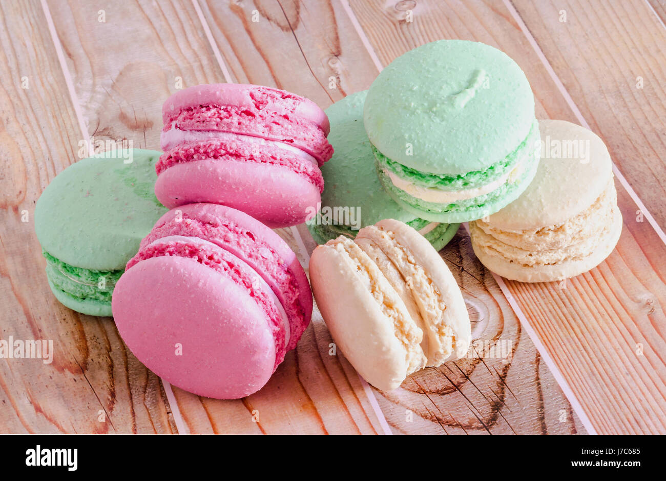 Colored sweet macaroons, french traditional, cream, white plate, close ...