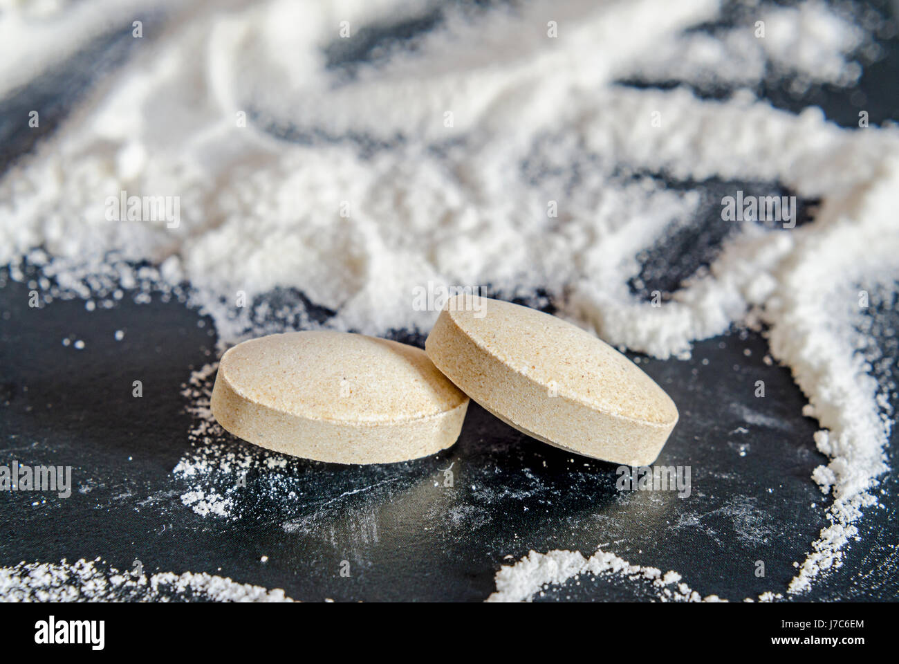 Yellow drugs pills and white powder, bunch, medical, homeopathic, black ...