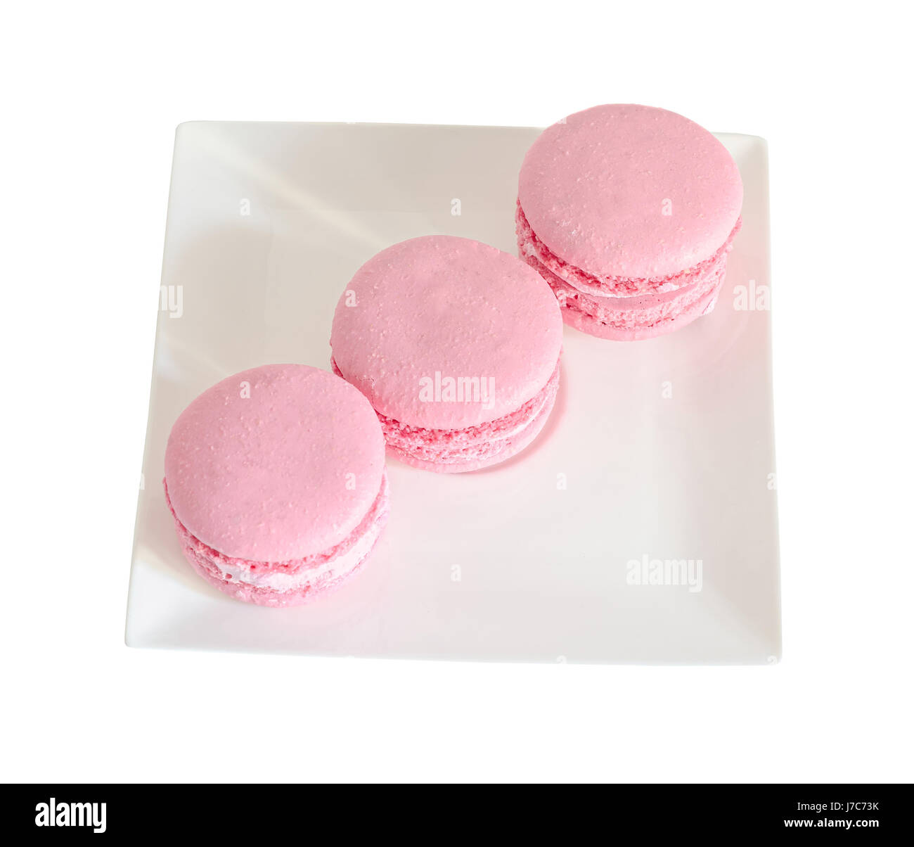 Pink sweet macaroons, french traditional, cream, white plate, close up ...