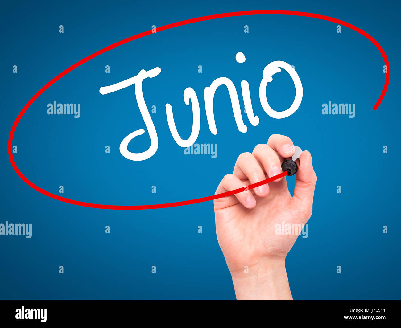 Man Hand writing Junio (June in Spanish) with black marker on visual ...