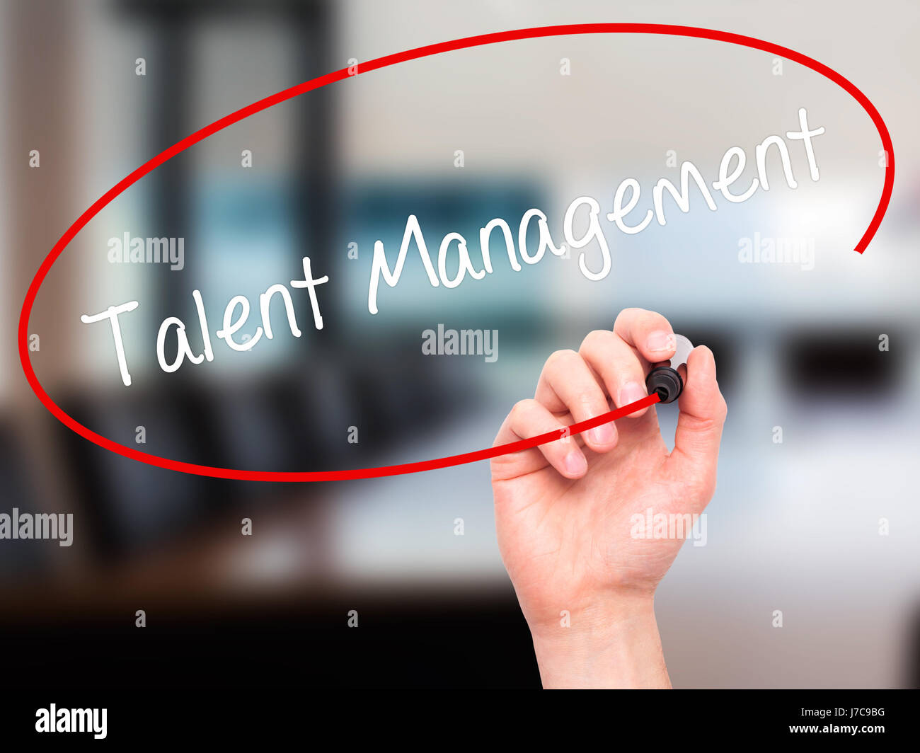 Man Hand writing Talent Management with black marker on visual screen ...