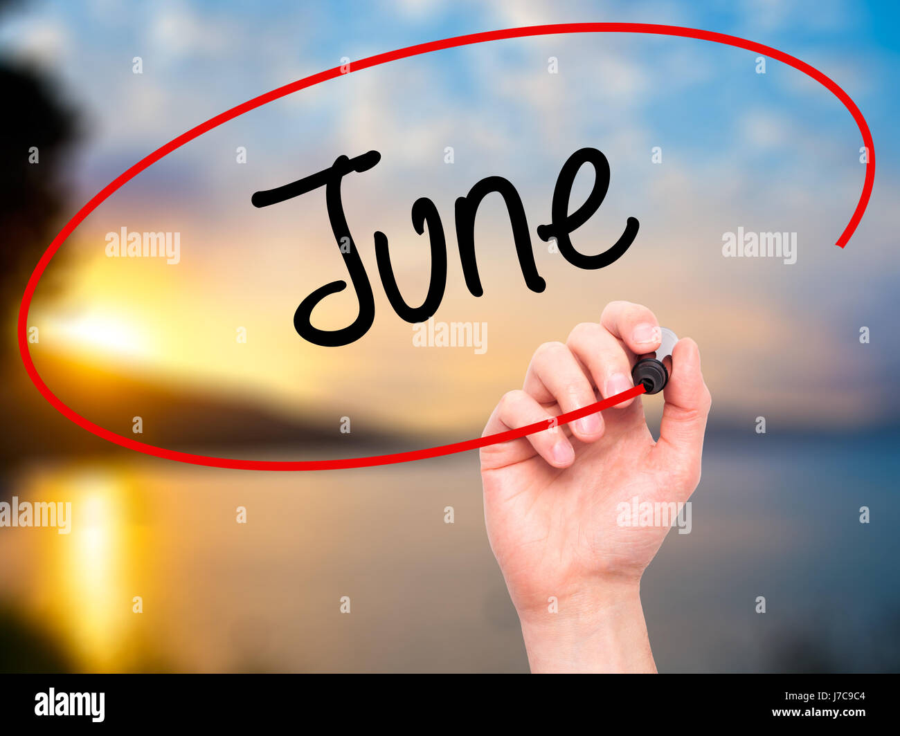 Man Hand writing June with black marker on visual screen. Isolated on ...