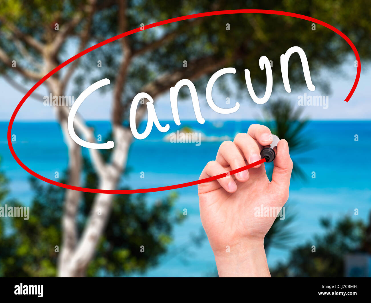 Man Hand writing Cancun with black marker on visual screen. Isolated on ...