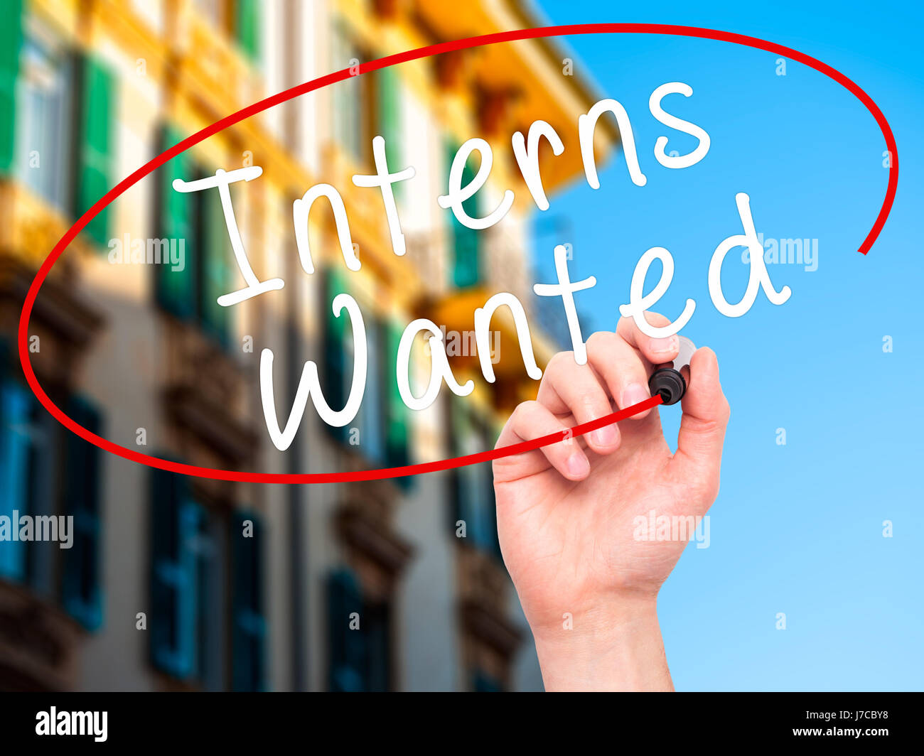 Man Hand writing Interns Wanted with black marker on visual screen ...