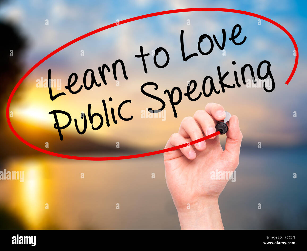 Man Hand writing Learn to Love Public Speaking with black marker on ...