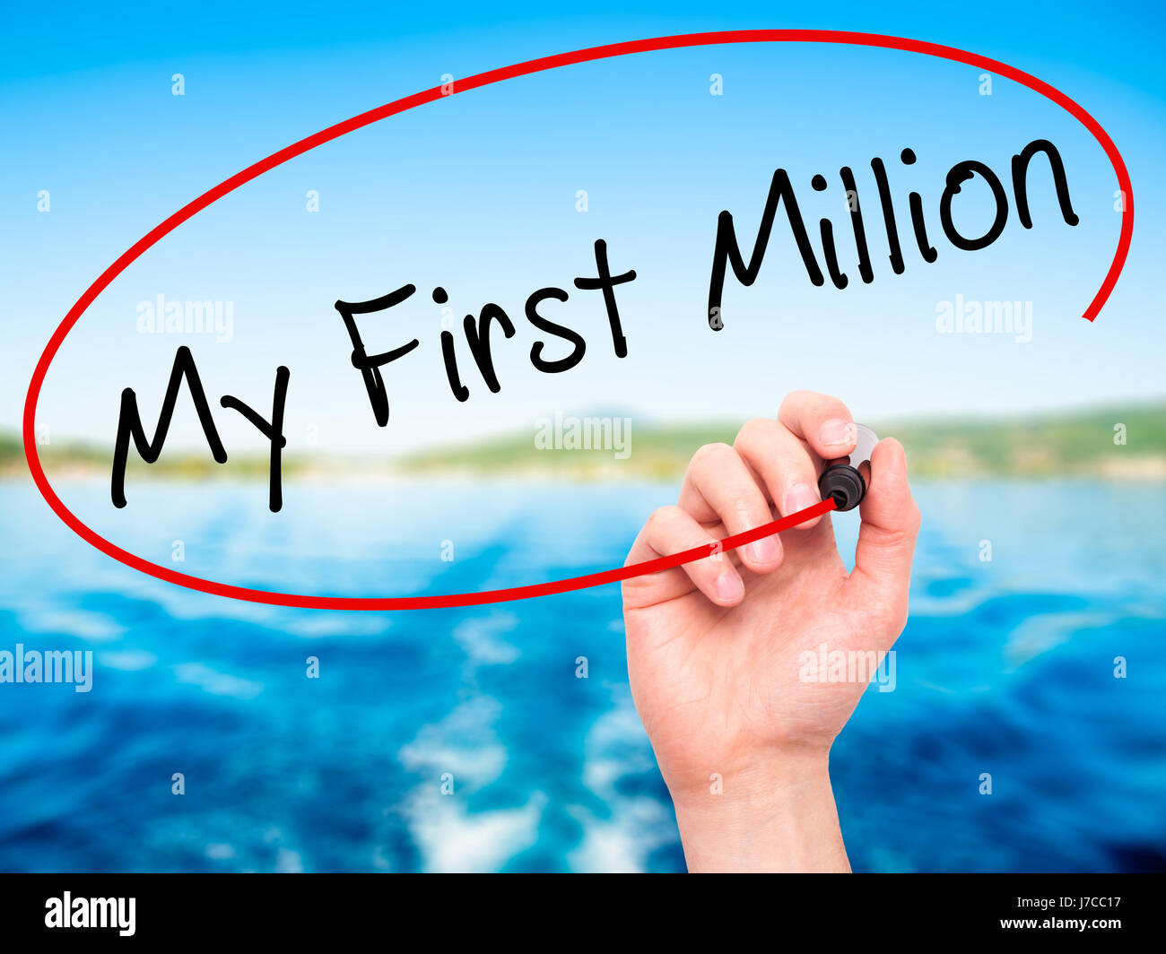 Man Hand writing My First Million with black marker on visual screen ...