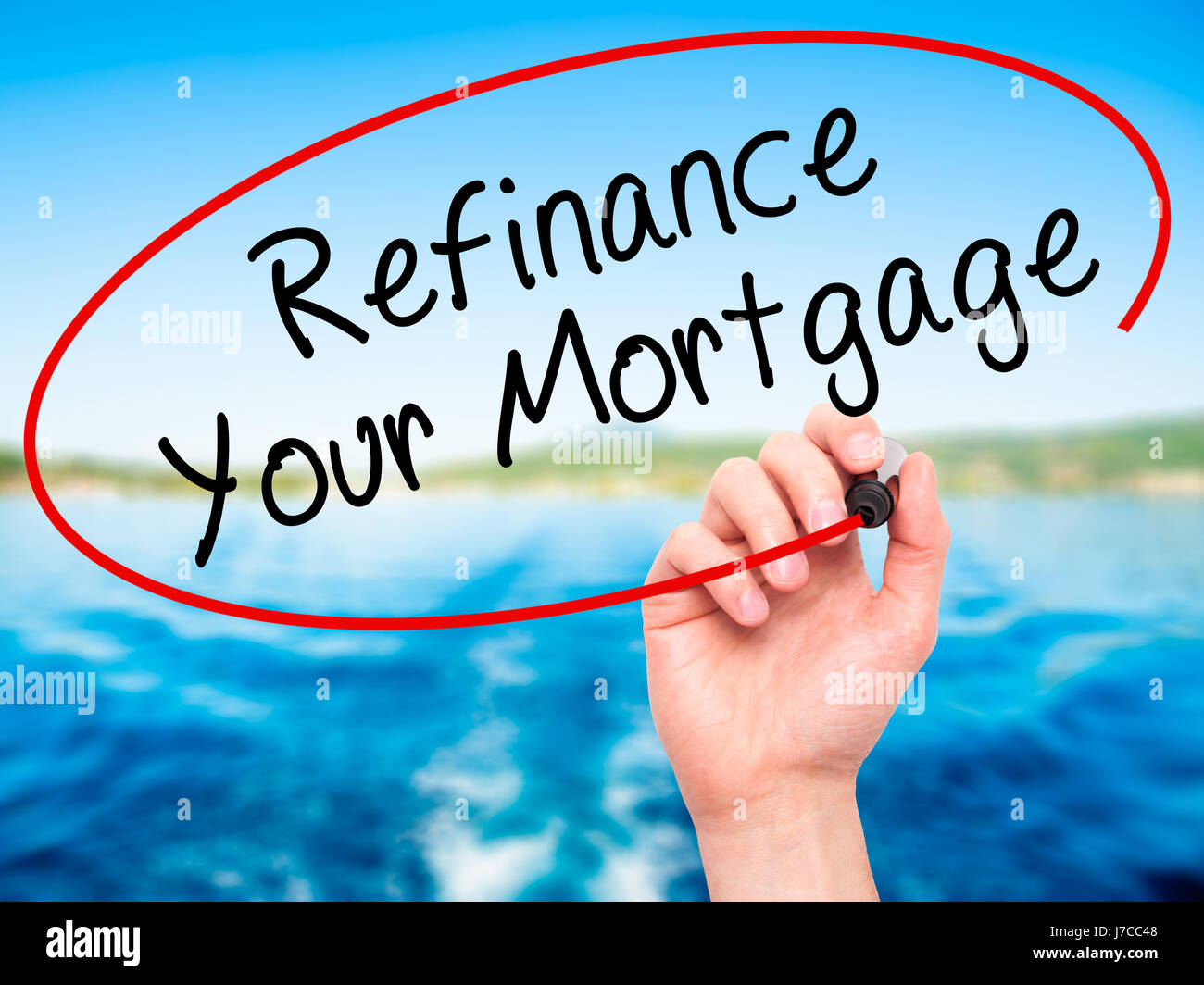 Man Hand writing Refinance Your Mortgage with black marker on visual ...