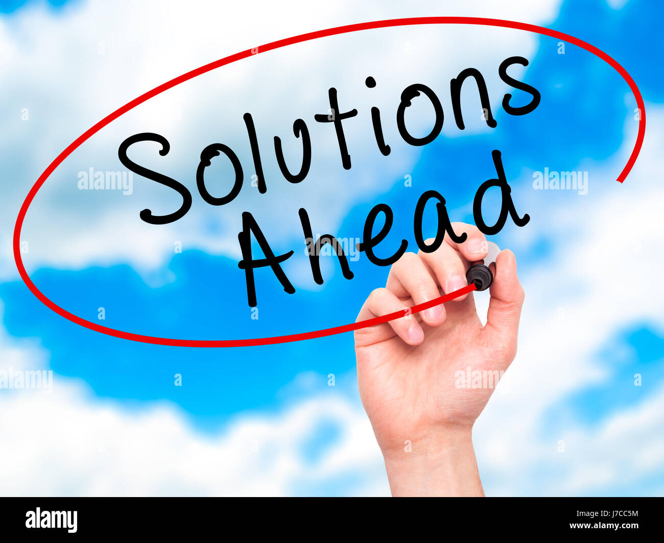 Man Hand writing Solutions Ahead with black marker on visual screen ...