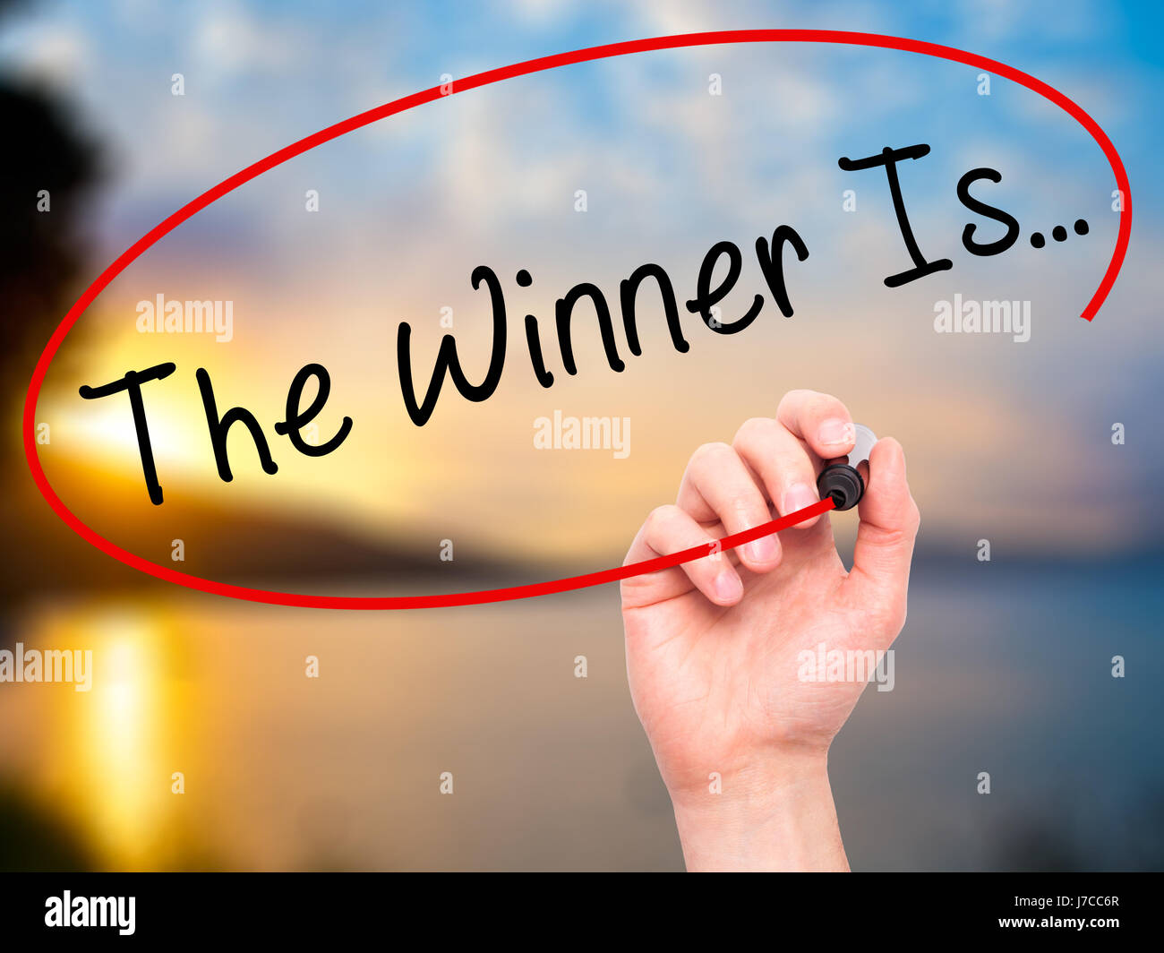 Man Hand writing The Winner Is... with black marker on visual screen ...