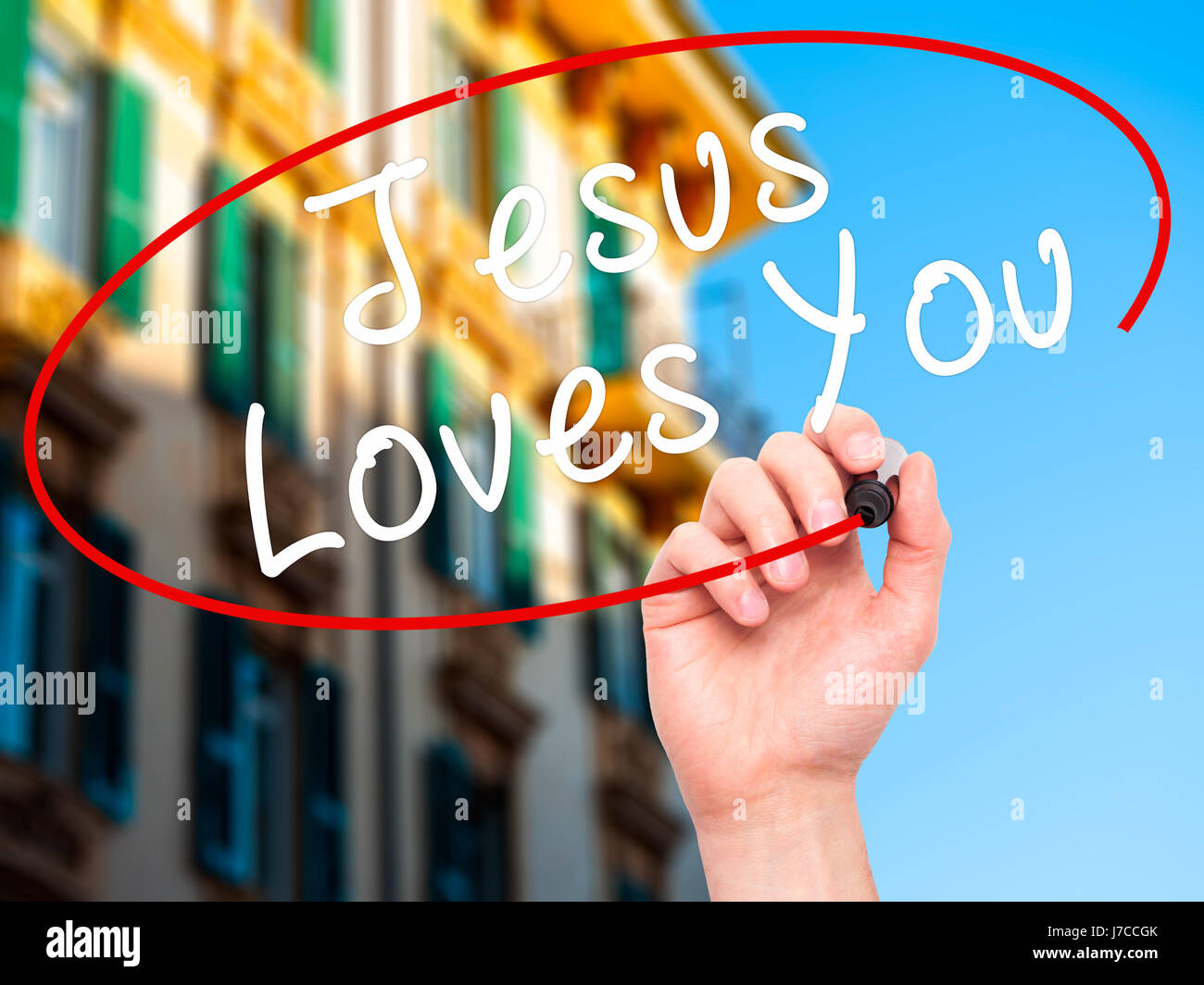 Man Hand writing Jesus Loves You with black marker on visual screen ...